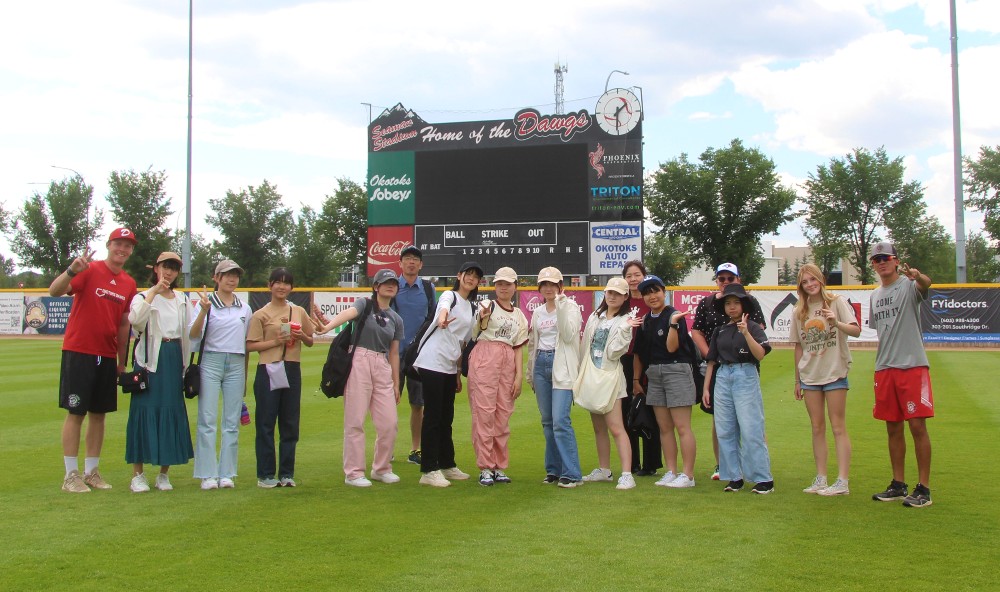 Japanese students step up to the plate at Dawgs stadium - OkotoksOnline ...