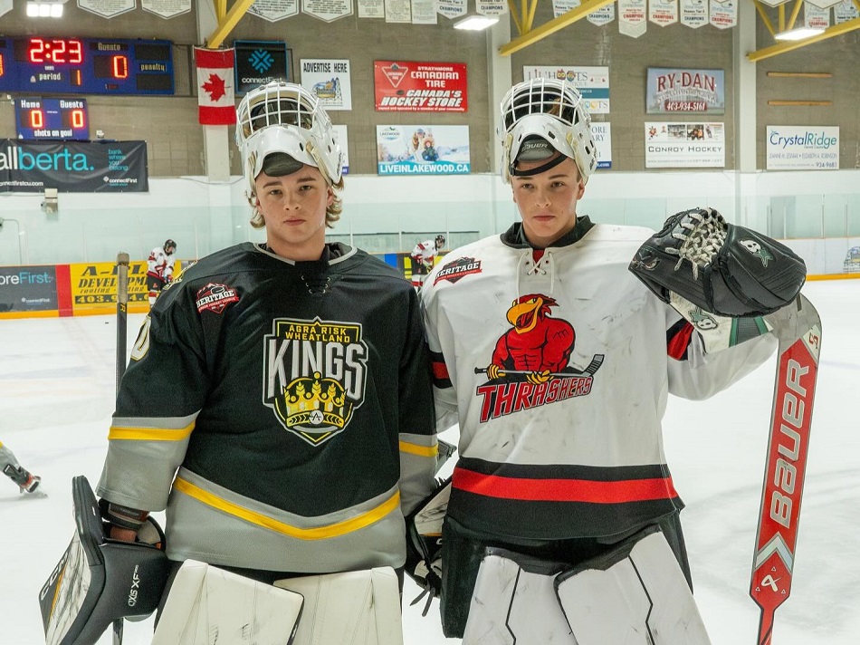 Identical twins on opposite sides of the ice during Agra Risk Wheatland ...