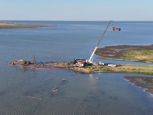 Stuck excavator back on shore after 11 years stuck in Big Quill Lake ...